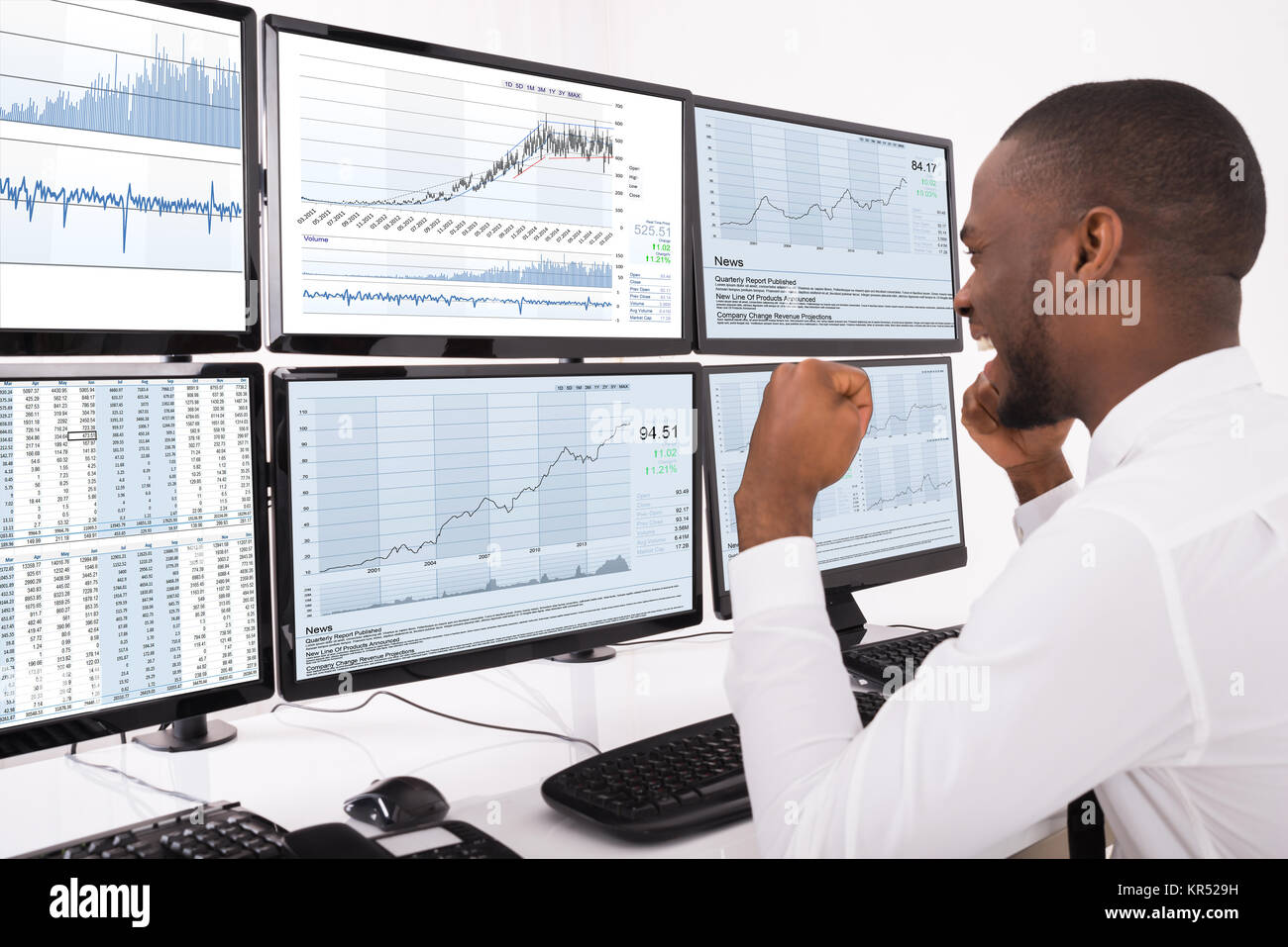 Happy Stock Market Broker Looking At Graphs On Multiple Computer Stock ...
