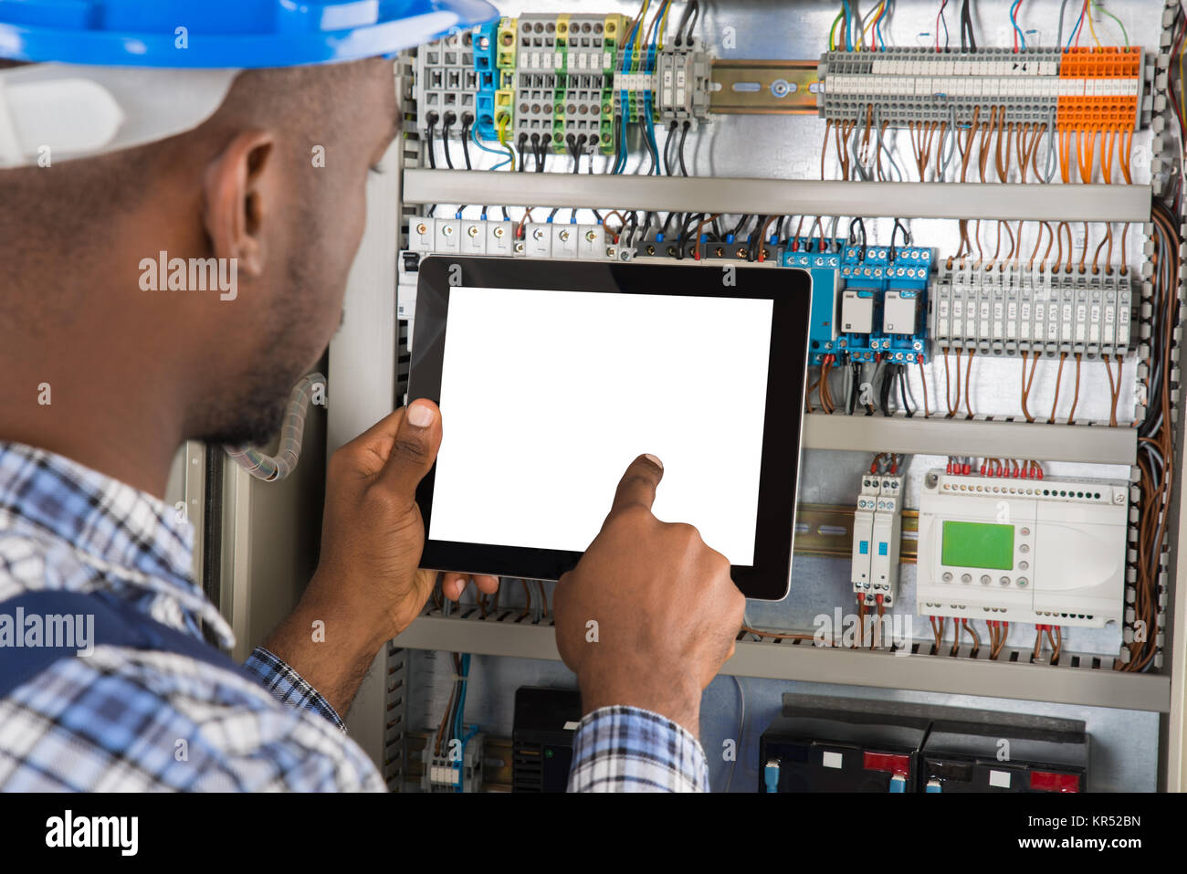 Technician Using Digital Tablet While Examining Fusebox Stock Photo - Alamy