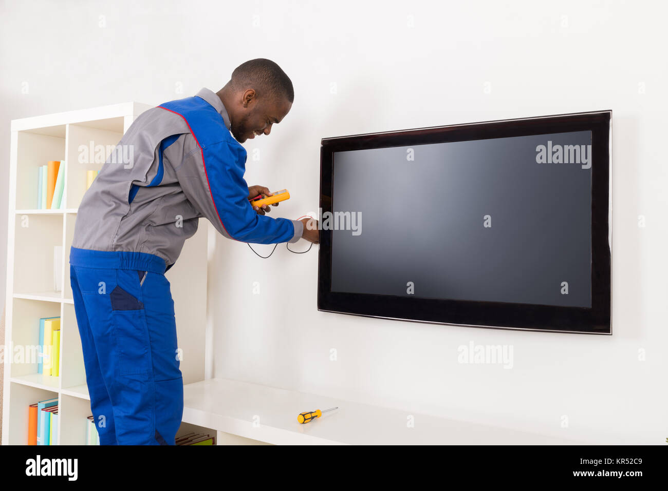 Electrician Checking Television With Multimeter Stock Photo - Alamy
