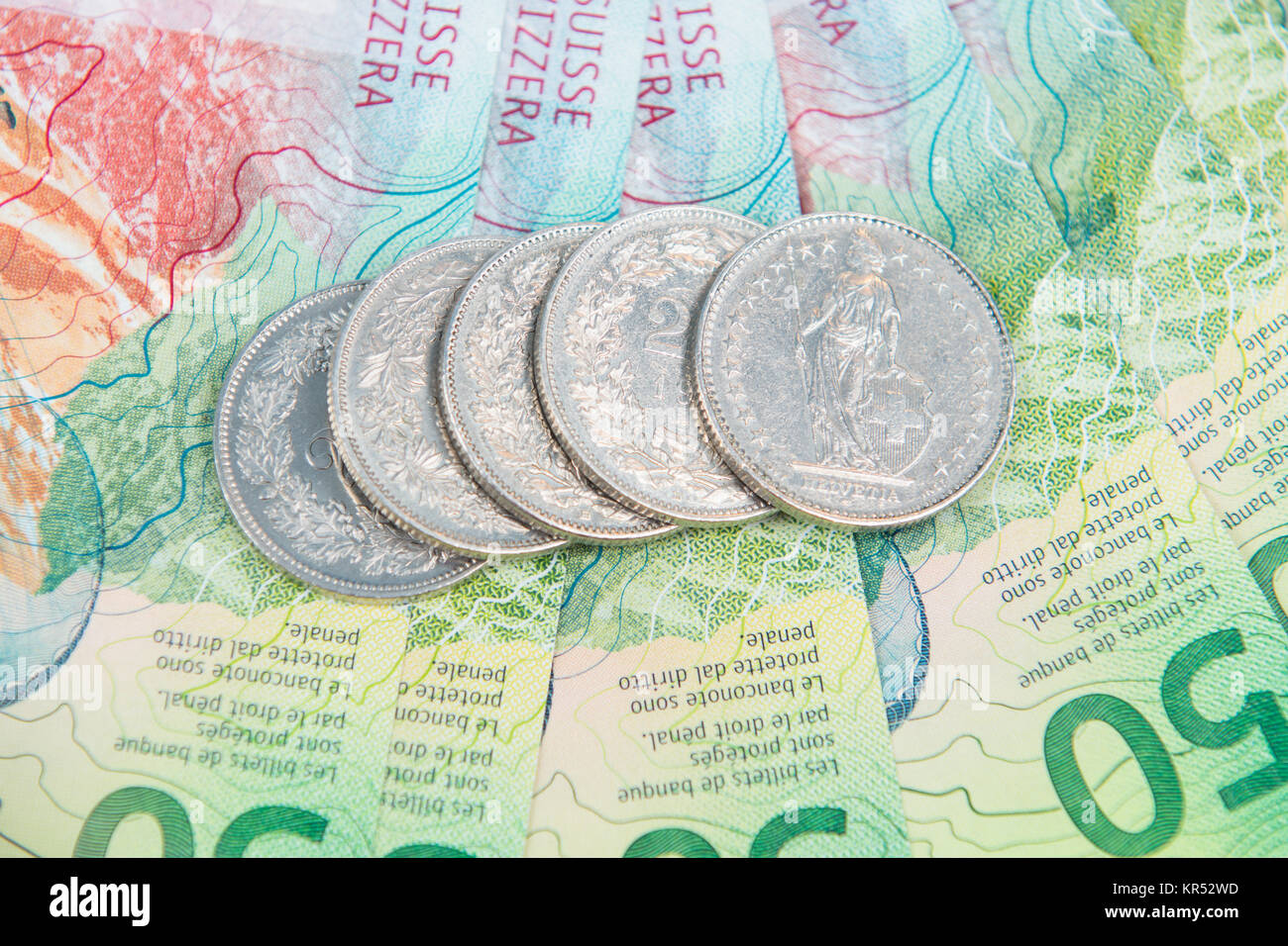 Swiss Franc silver coins on new swiss banknotes as background or ...