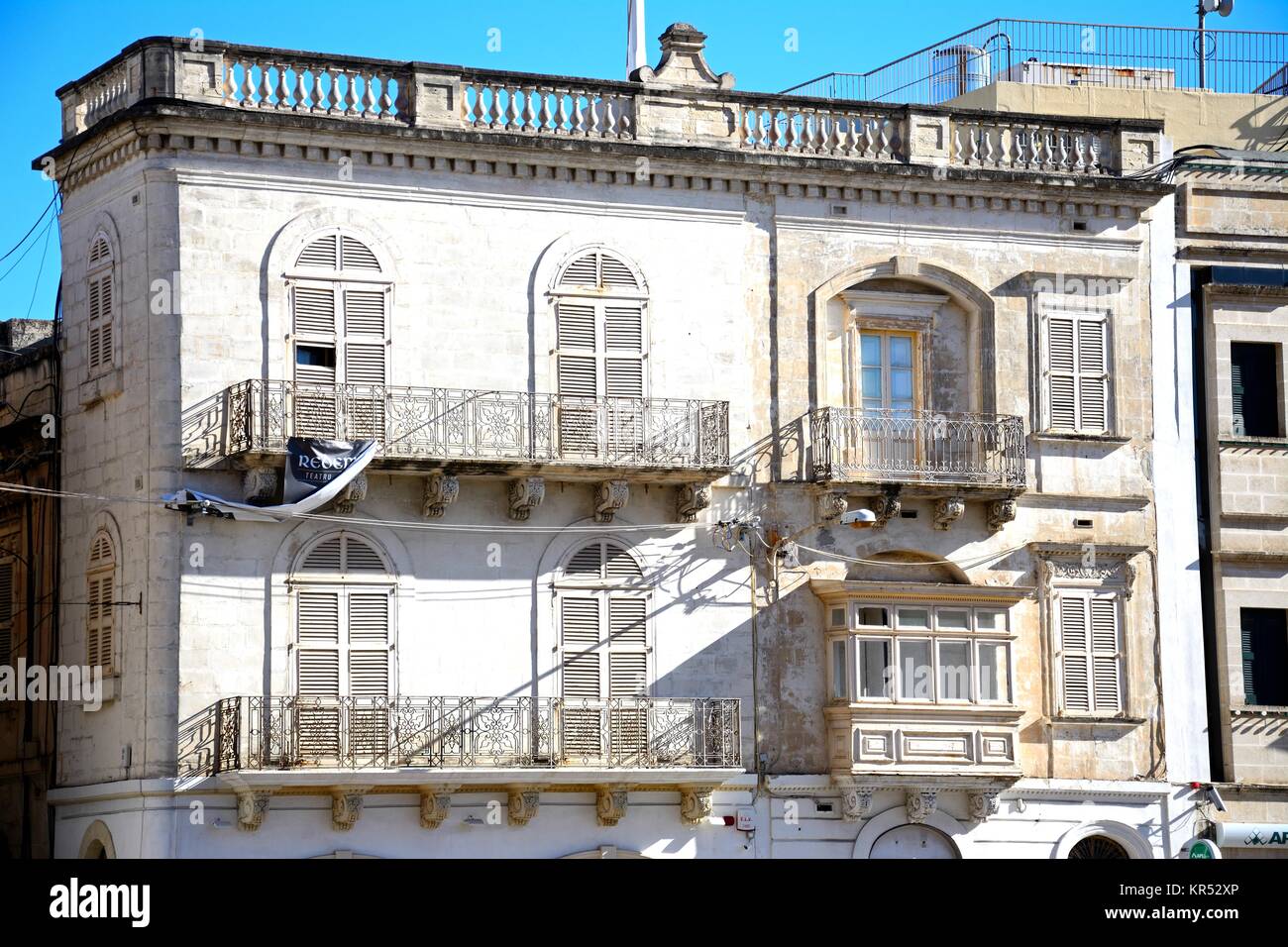 Traditional Maltese building with wrought iron balconies in the town ...