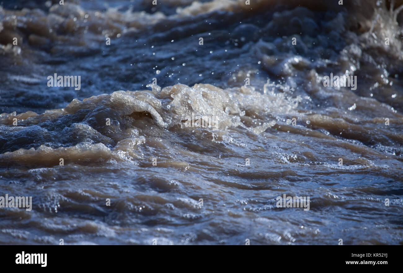rapid stream of muddy river Stock Photo - Alamy