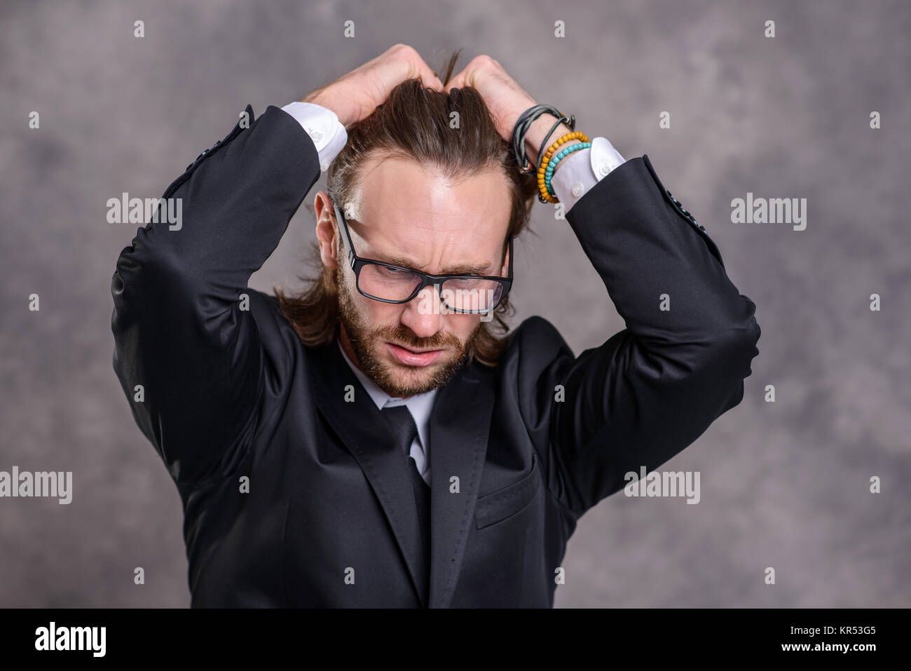 portrait of a young stressed business man in black suit Stock Photo - Alamy