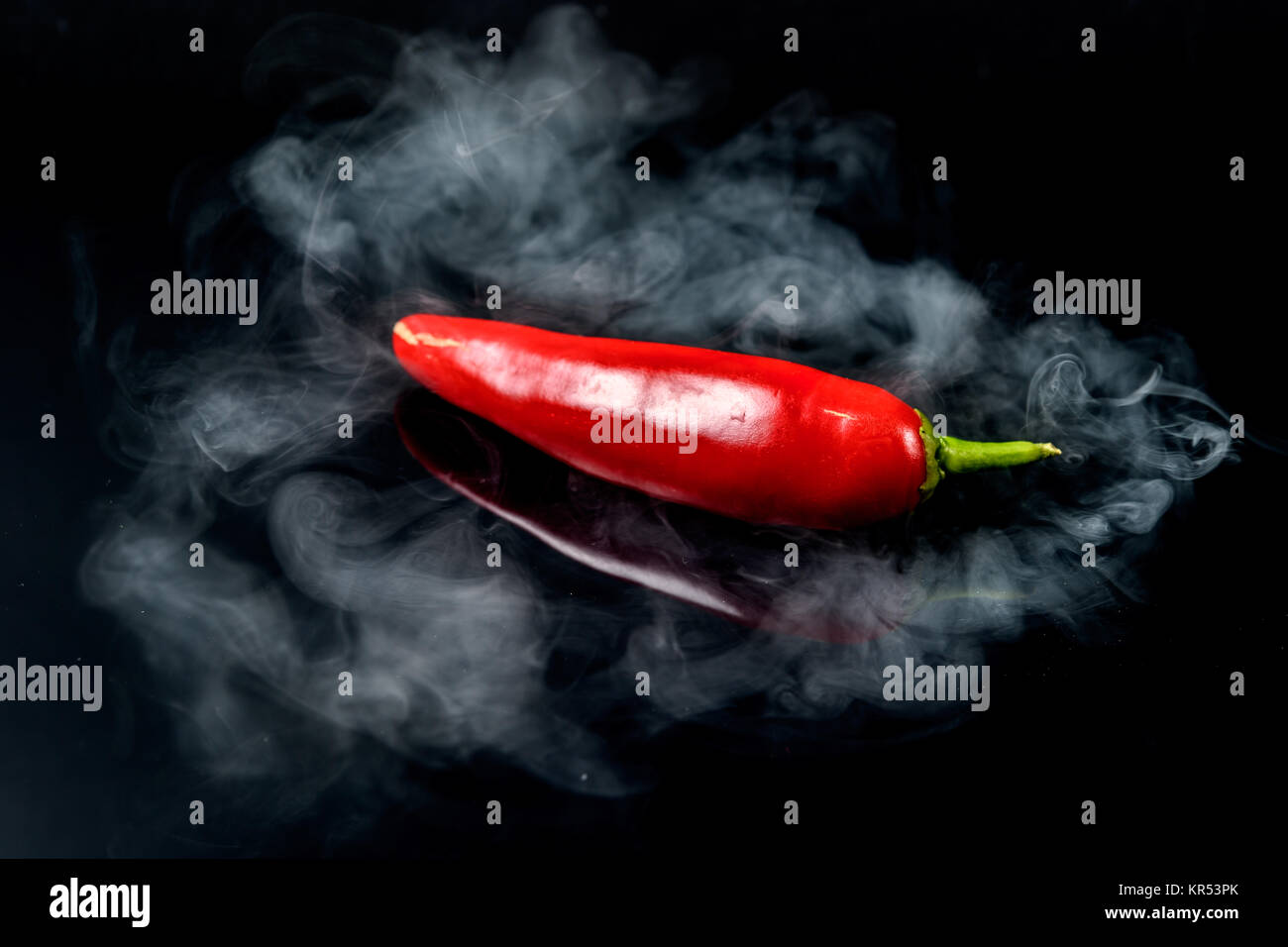 spicy red chilli shrouded in smoke Stock Photo - Alamy