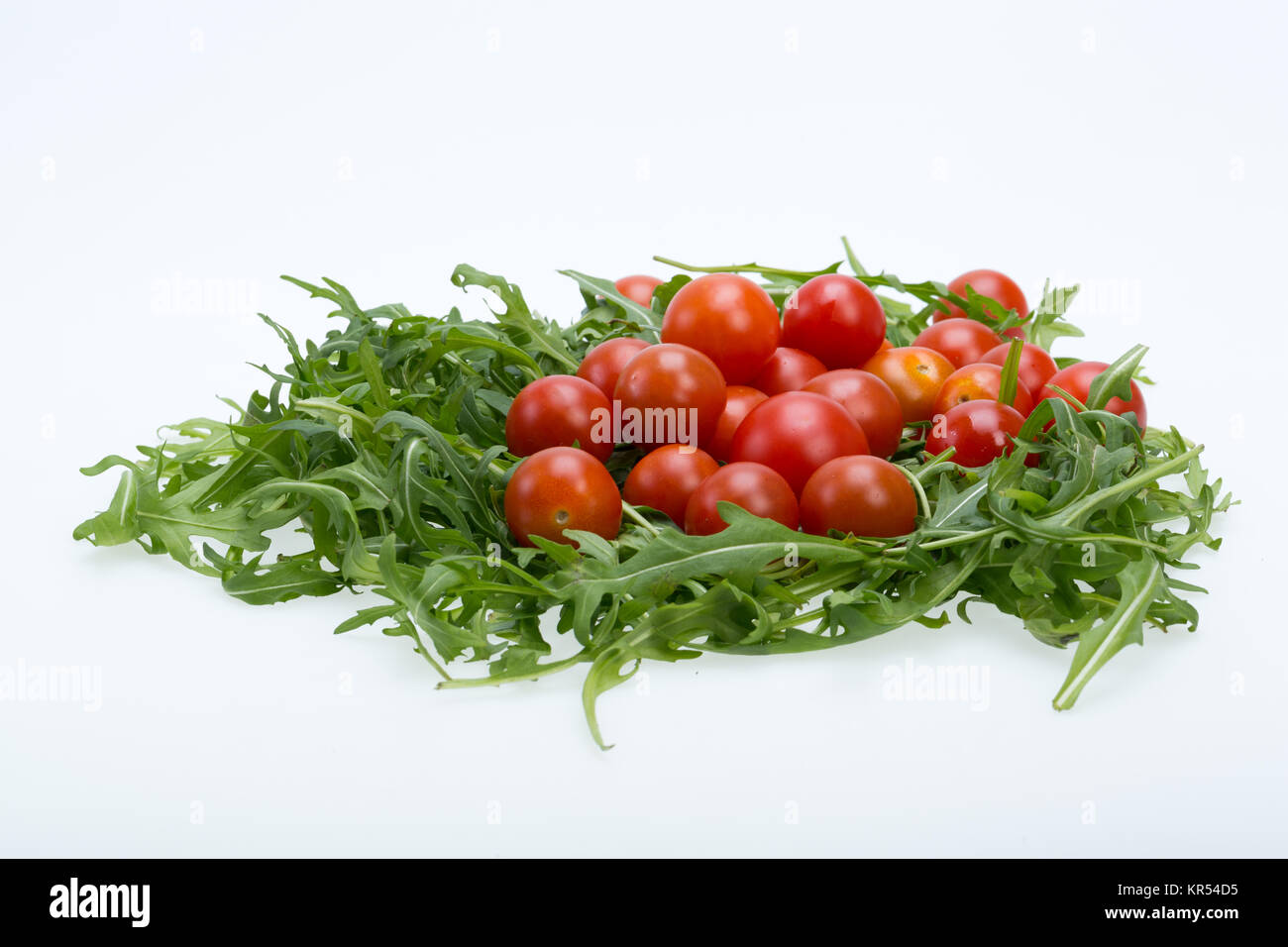 Heap of ruccola leaves and cherry tomatoes Stock Photo - Alamy