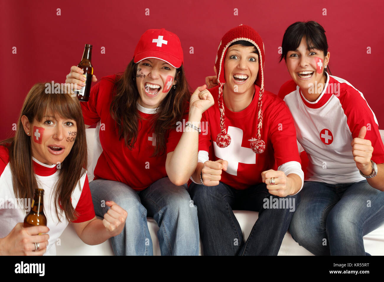 Photo of female Swiss sports fans smiling and cheering for their team ...