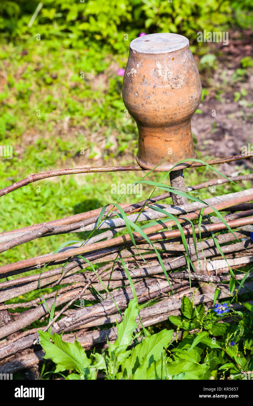 wattle hurdle with old clay pot Stock Photo - Alamy