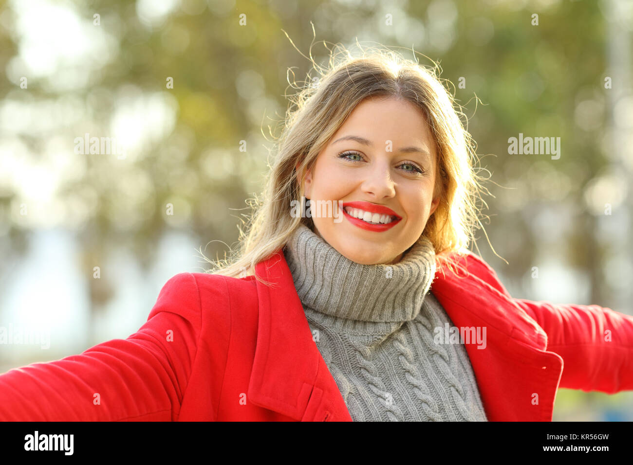 Front view portrait of a happy lady posing looking at camera in a park ...