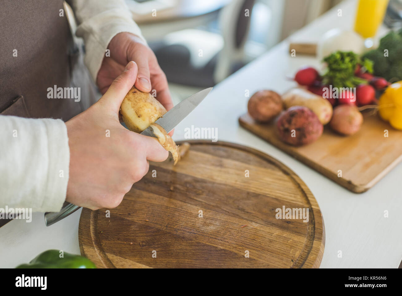 Man slicing potato Stock Photo - Alamy