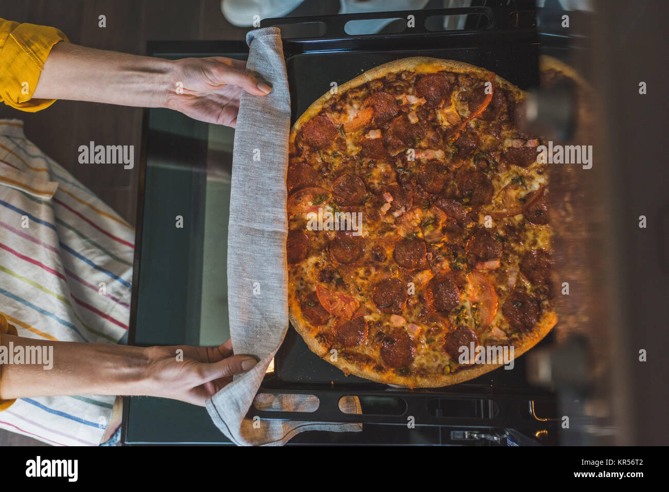 Woman cooking pizza Stock Photo - Alamy