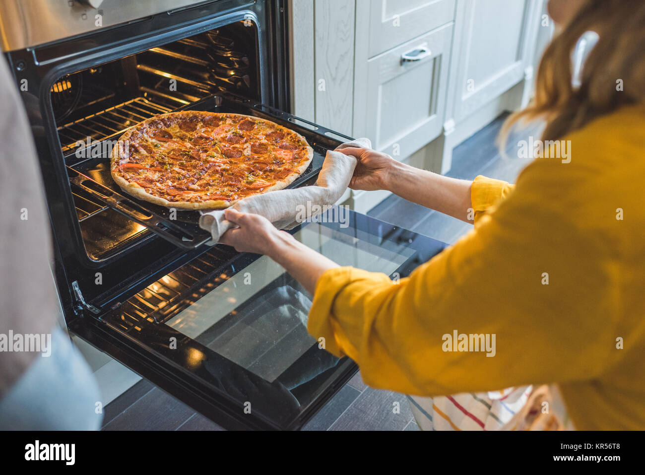Woman cooking pizza Stock Photo - Alamy