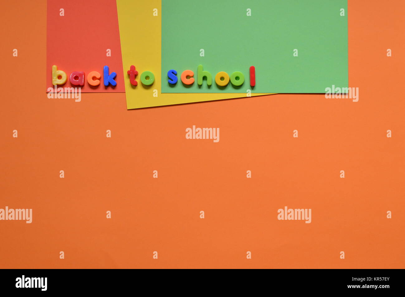 The words BACK TO SCHOOL with magnetic letters on colorful paperboard ...