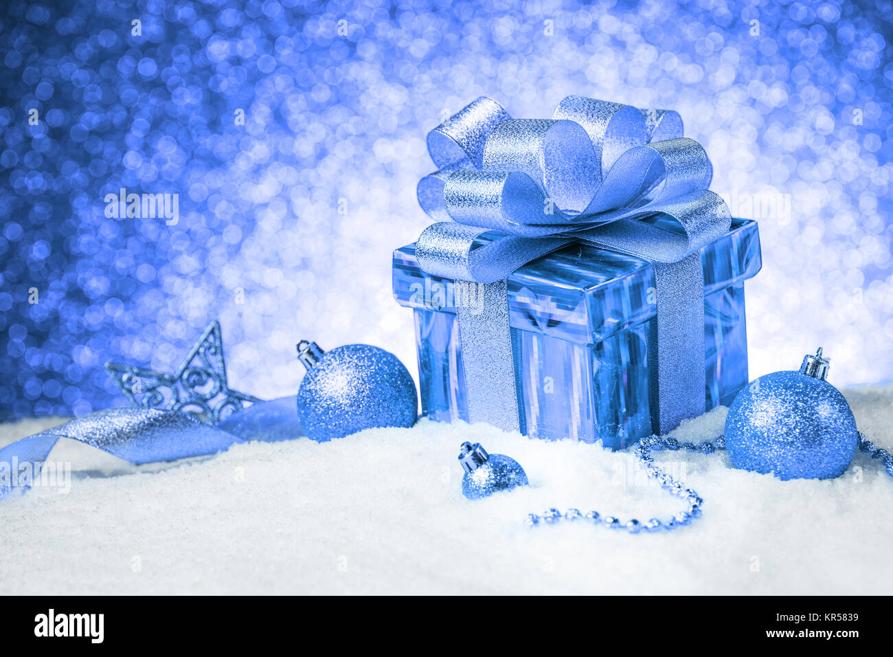 Christmas blue gift box with balls and decoration on snow Stock Photo ...
