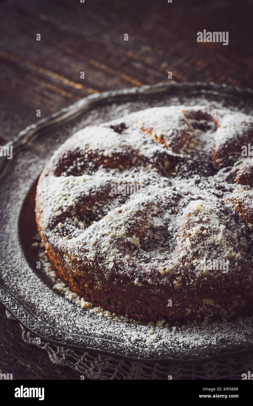 Cake with icing sugar on the dark wooden table with lace napkin Stock ...