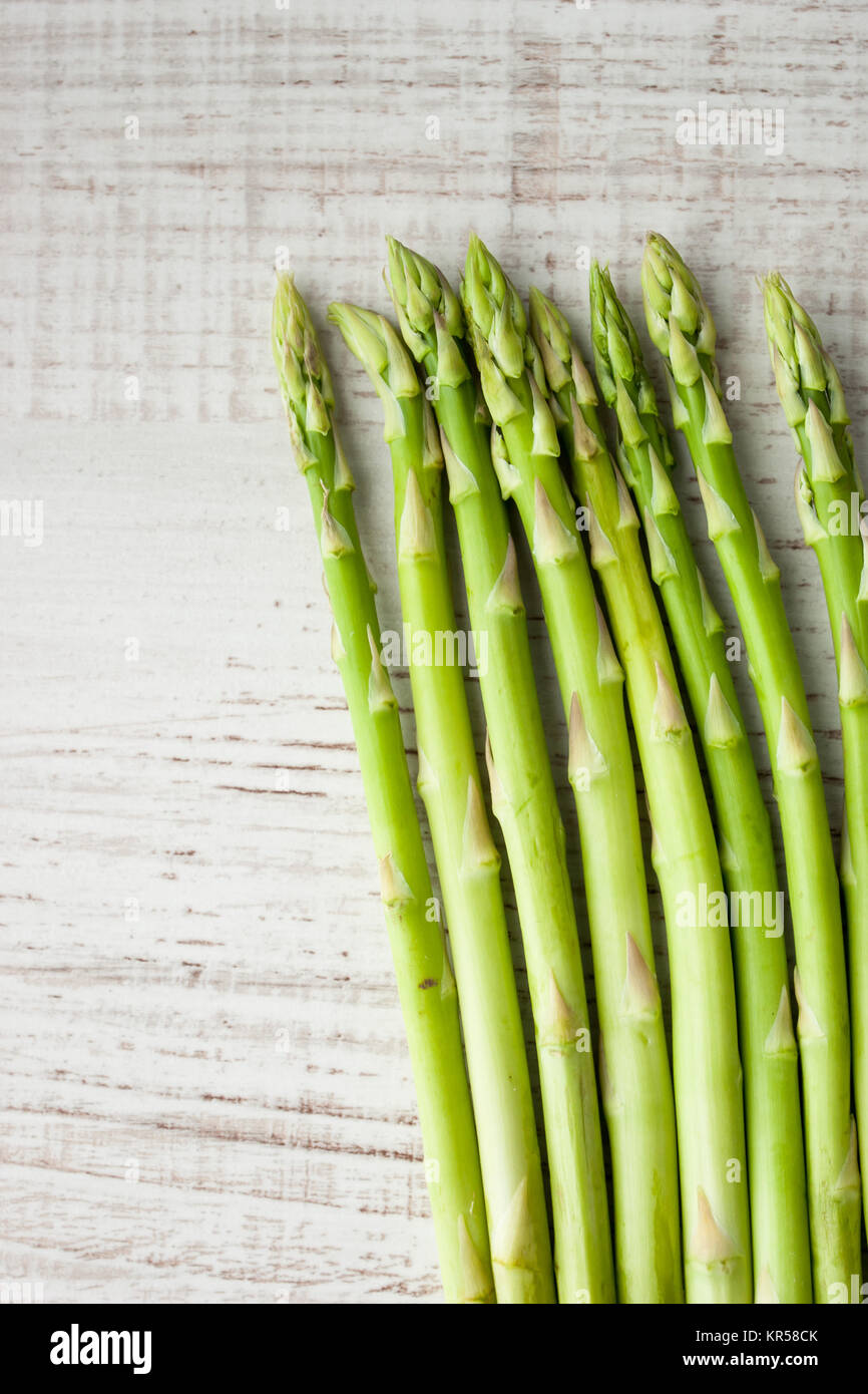 Asparagus on the white table vertical Stock Photo - Alamy