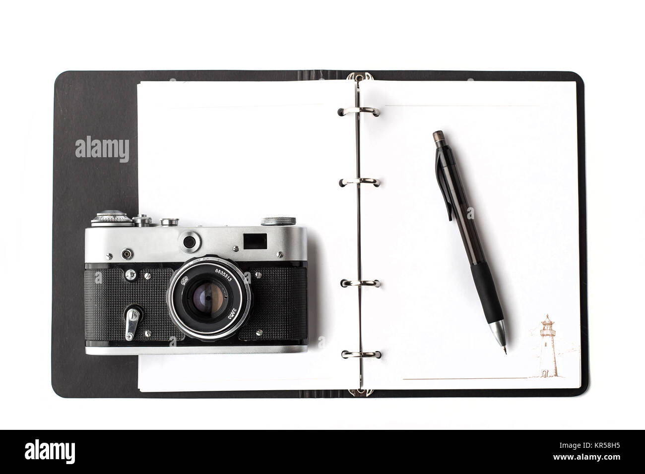 Open clear notebook with pen and camera Stock Photo - Alamy