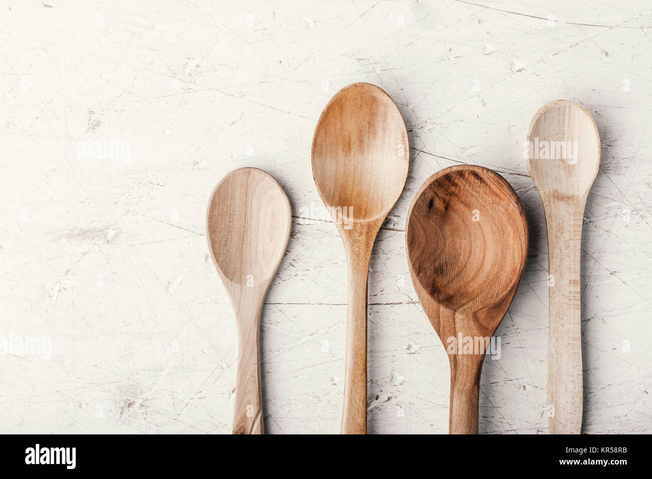 Wooden spoons on the white table horizontal Stock Photo - Alamy