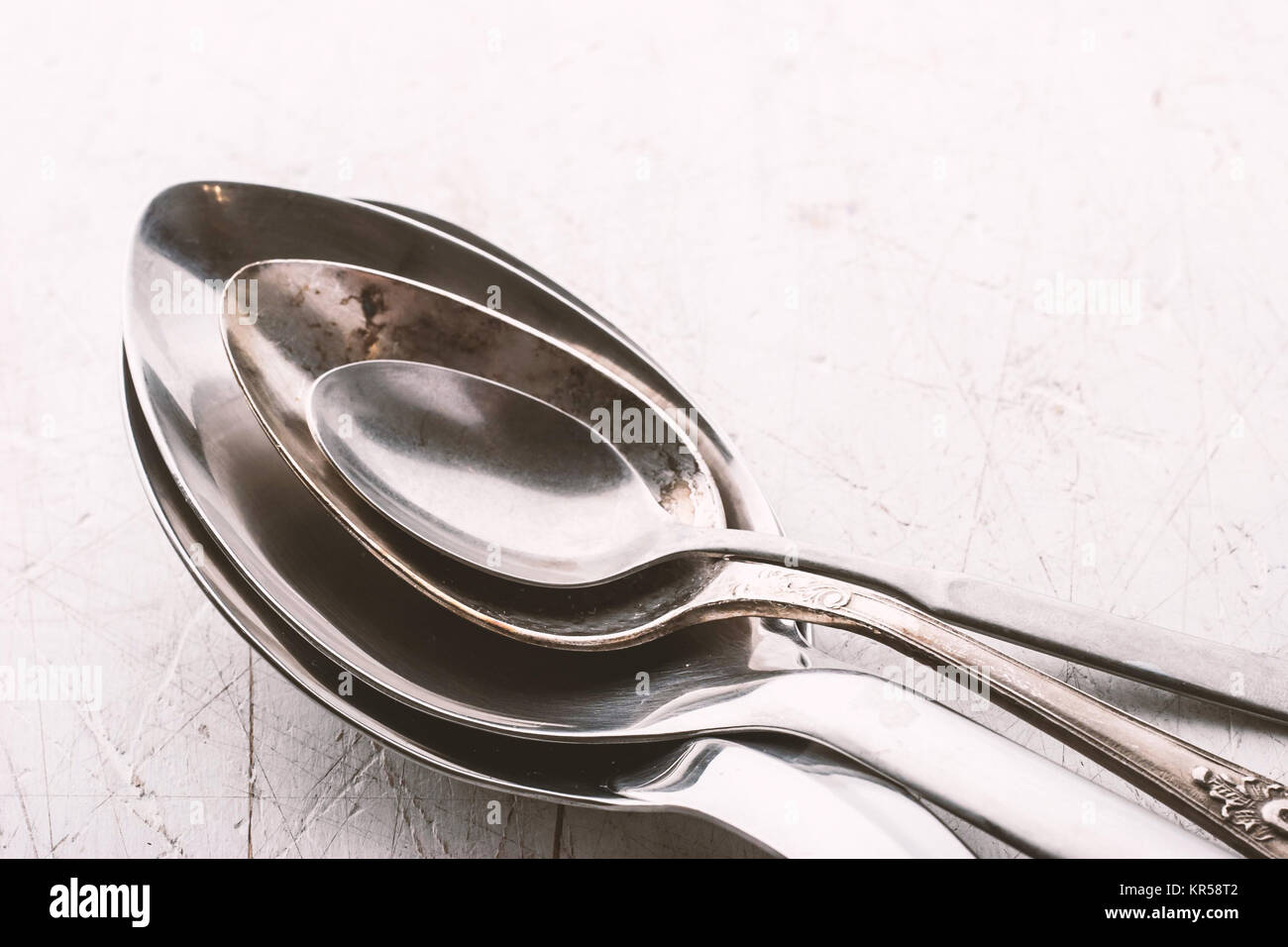 Set of metal spoon on the white table horizontal Stock Photo - Alamy