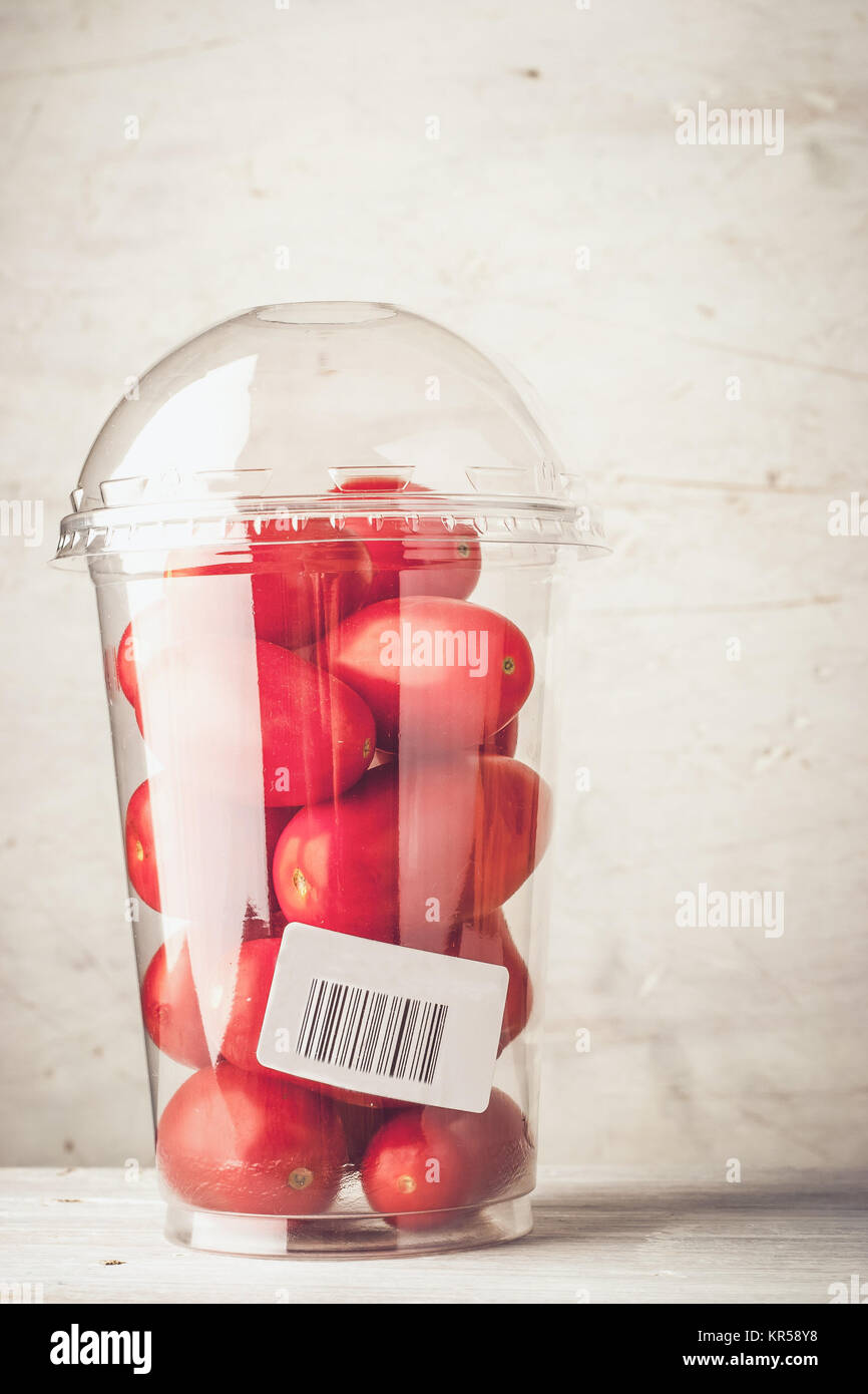 Tomatoes in the plastic package vertical Stock Photo - Alamy
