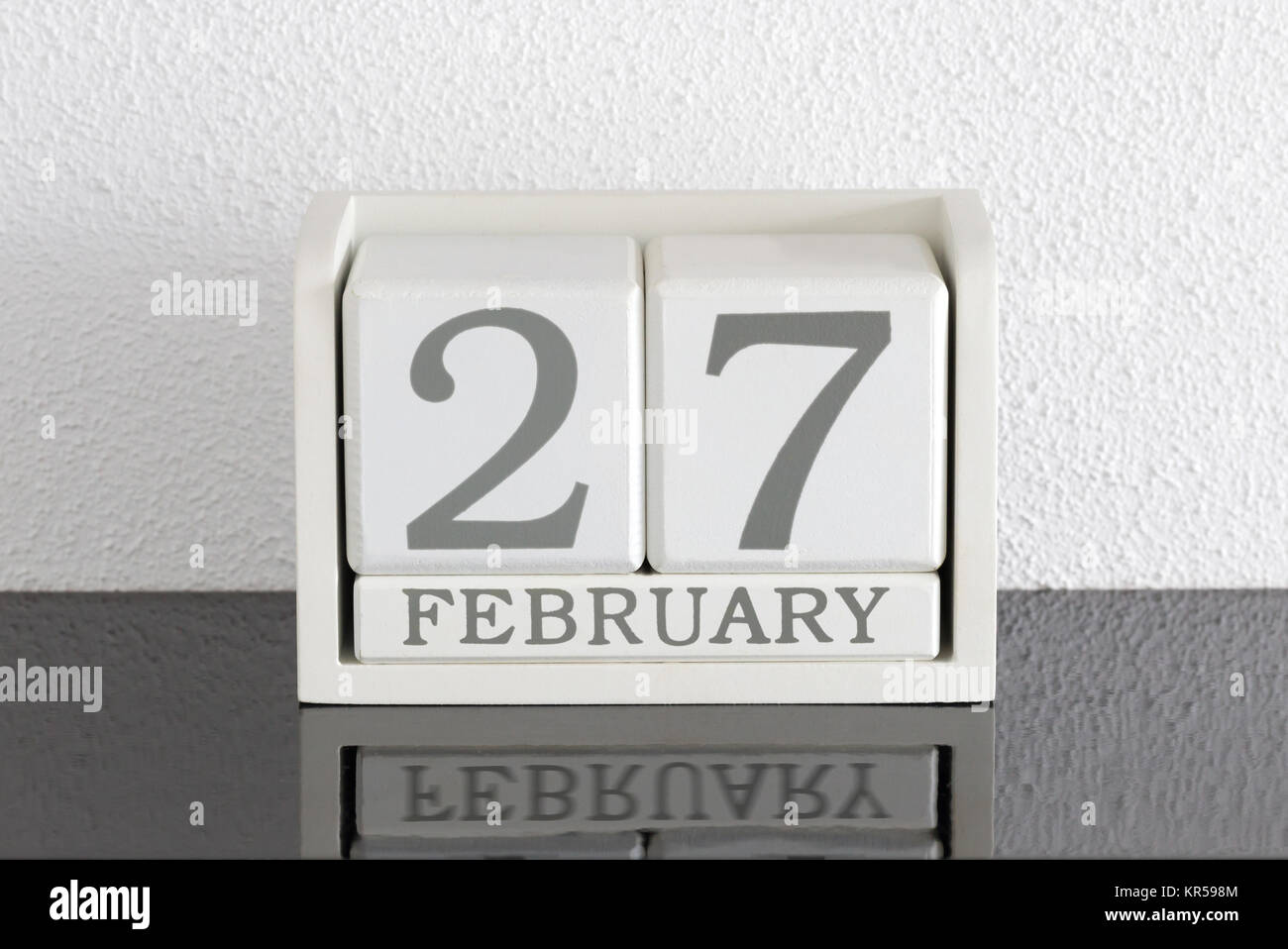 White block calendar present date 27 and month February on white wall ...