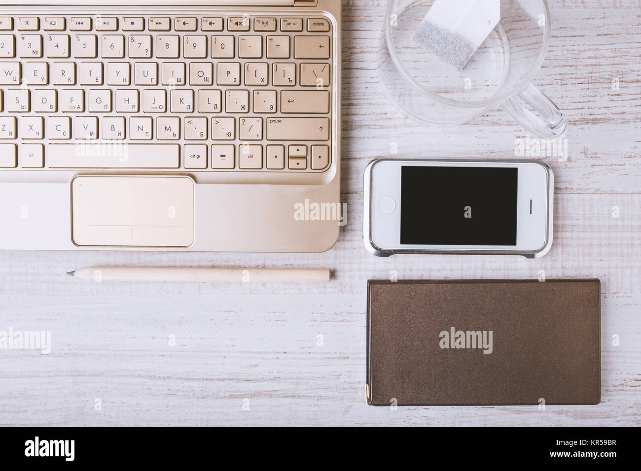 Laptop, mobile phone, notebook on a wooden table Stock Photo - Alamy