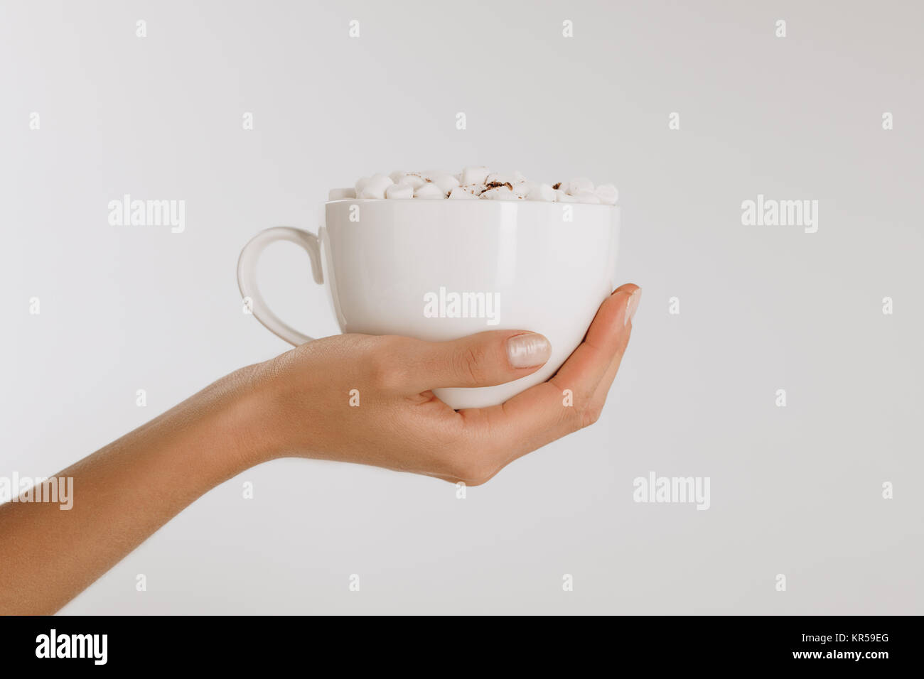 hand with cup of drink with marshmallows Stock Photo - Alamy
