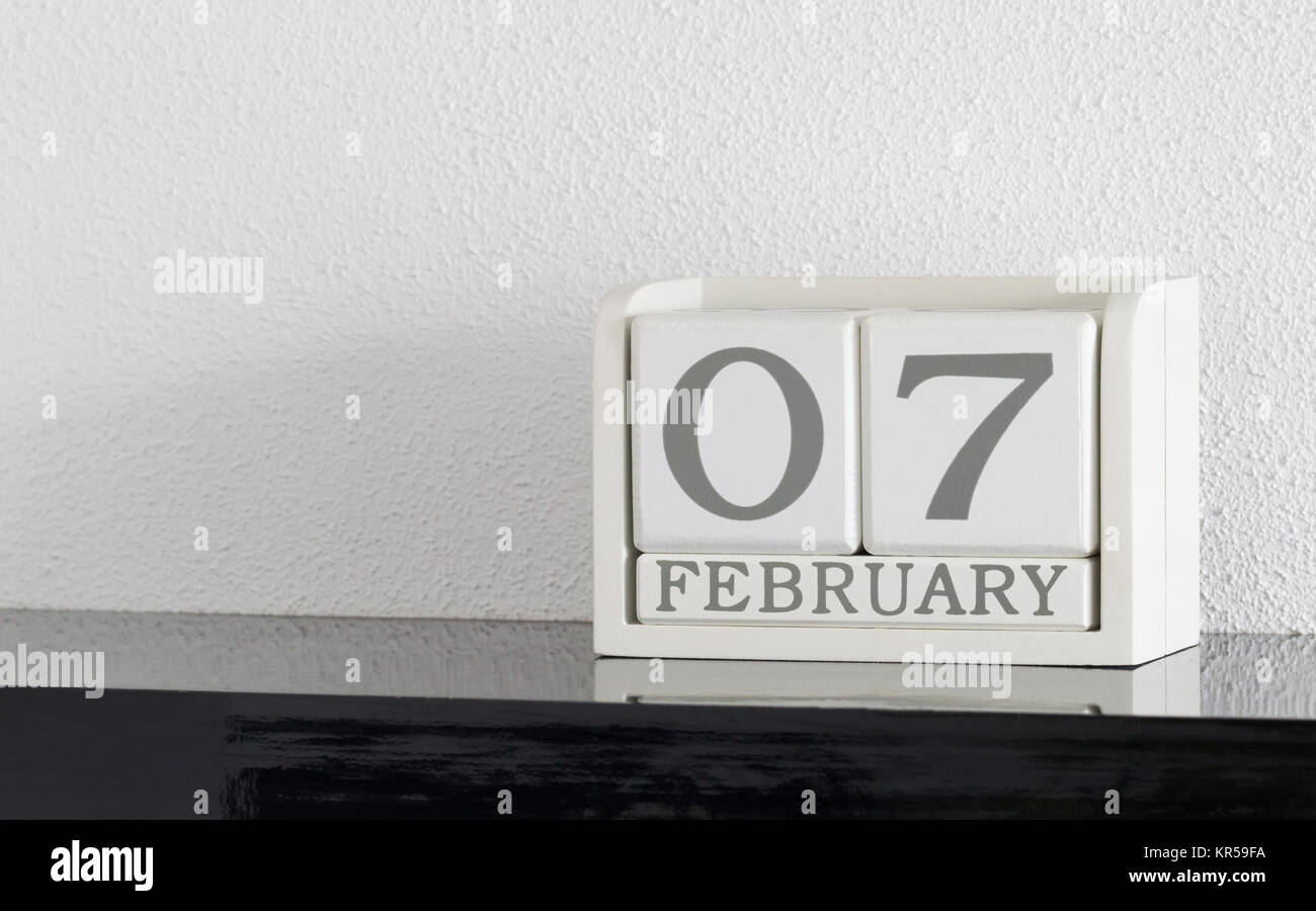 White block calendar present date 7 and month February on white wall ...