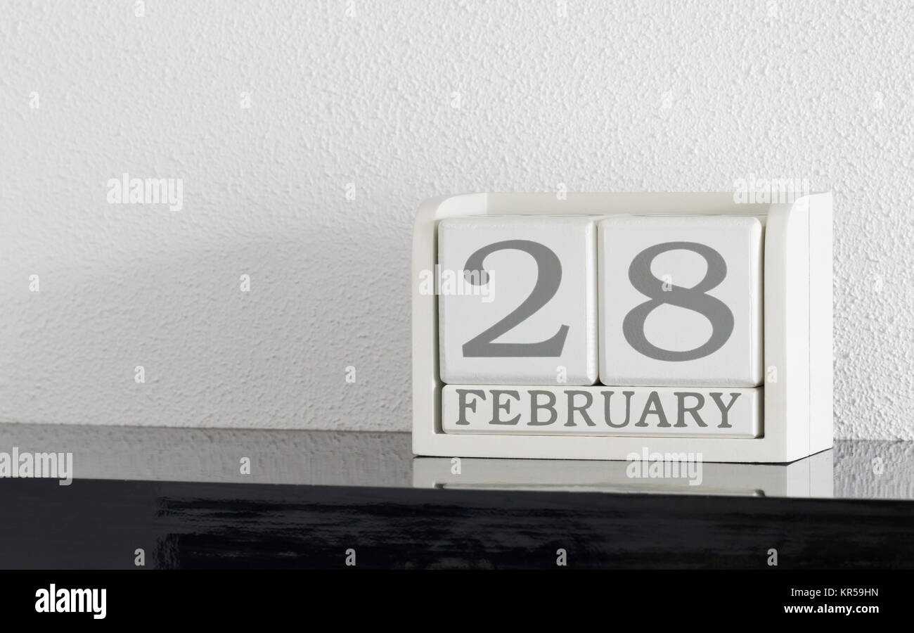 White block calendar present date 28 and month February on white wall ...