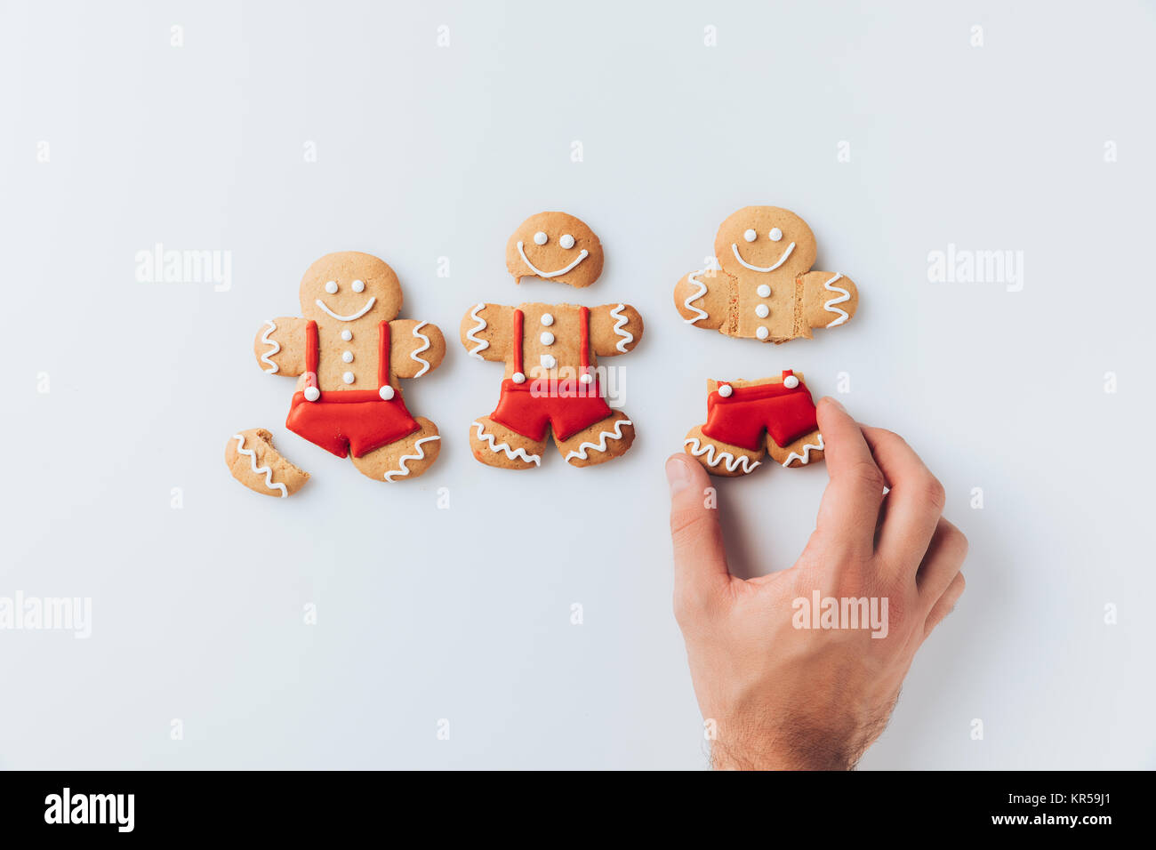 hand with crashed gingerbread men Stock Photo - Alamy