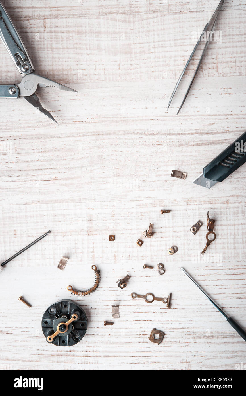 Tools and disassembled mechanism on the desktop Stock Photo - Alamy