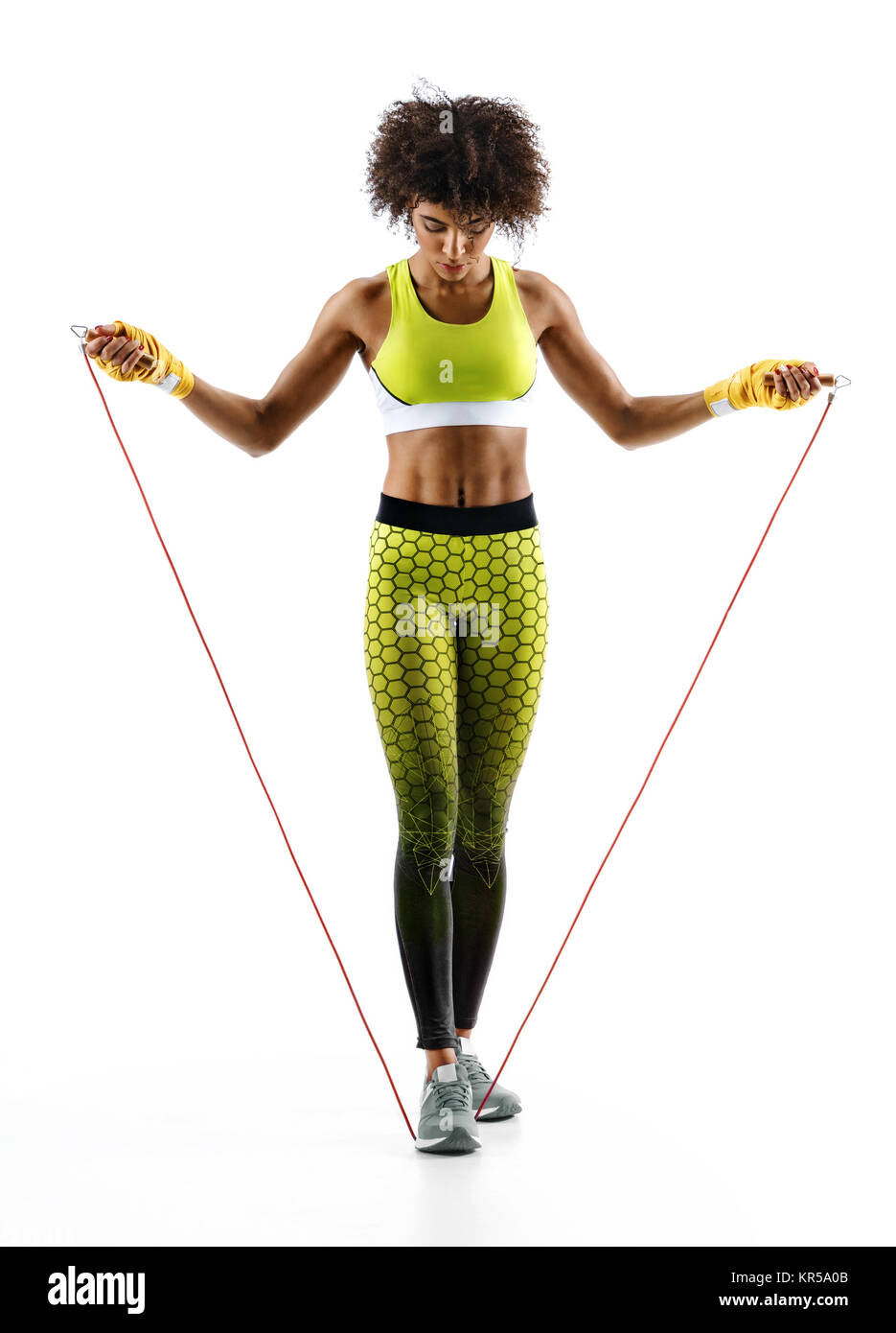 Athletic girl with a jump rope on white background. Best cardio workout ...