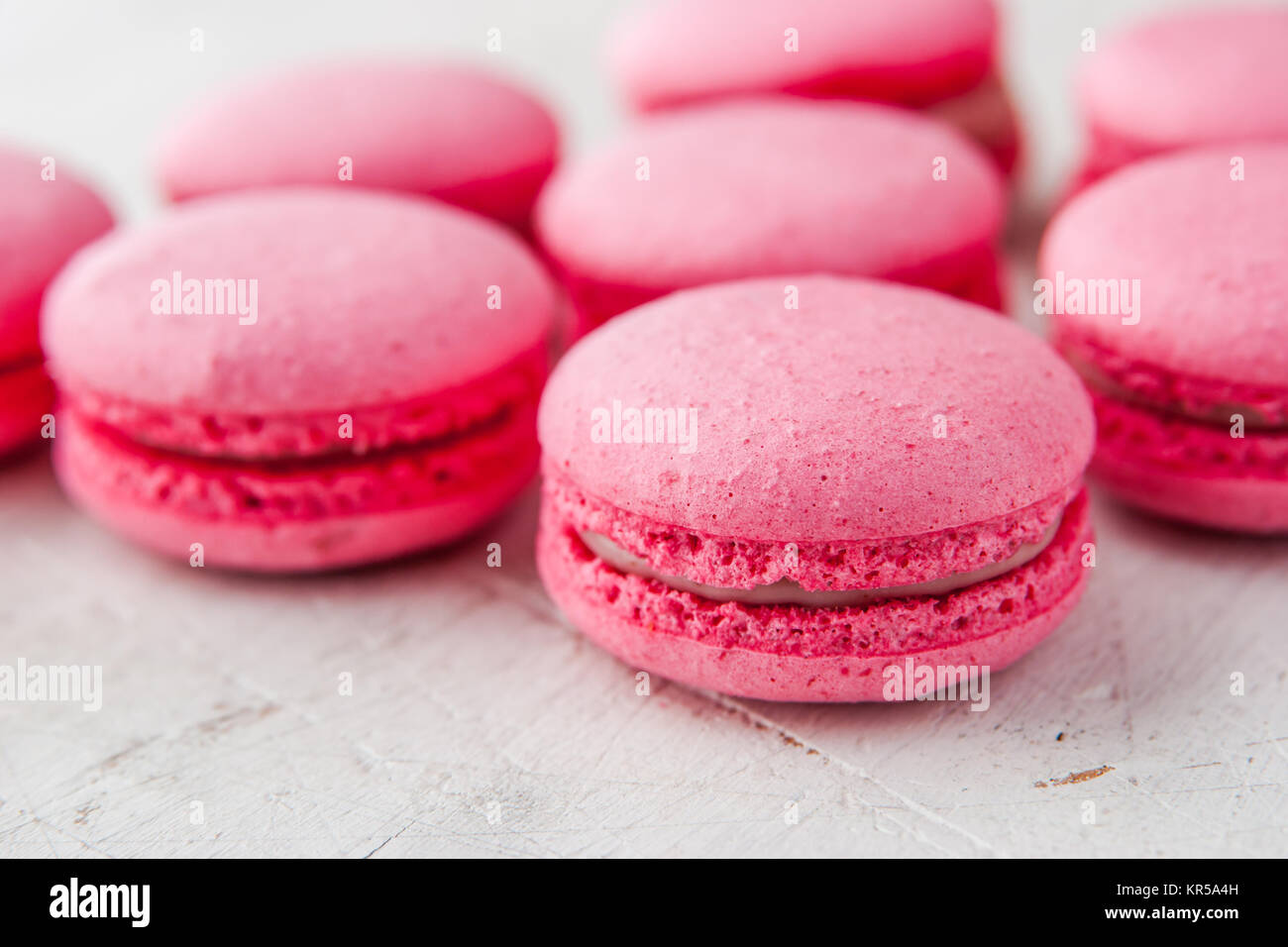 Pink macaroon on a white table Stock Photo - Alamy
