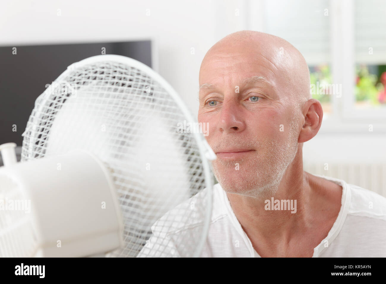mature man refreshed with a fan Stock Photo - Alamy