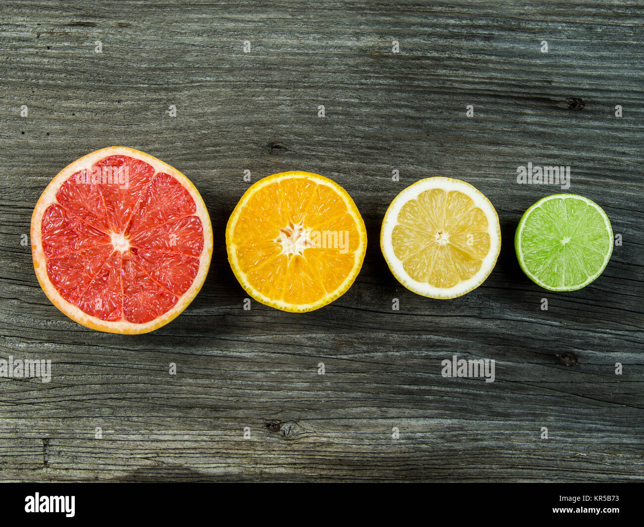 Fruit on wood background in a row Stock Photo - Alamy