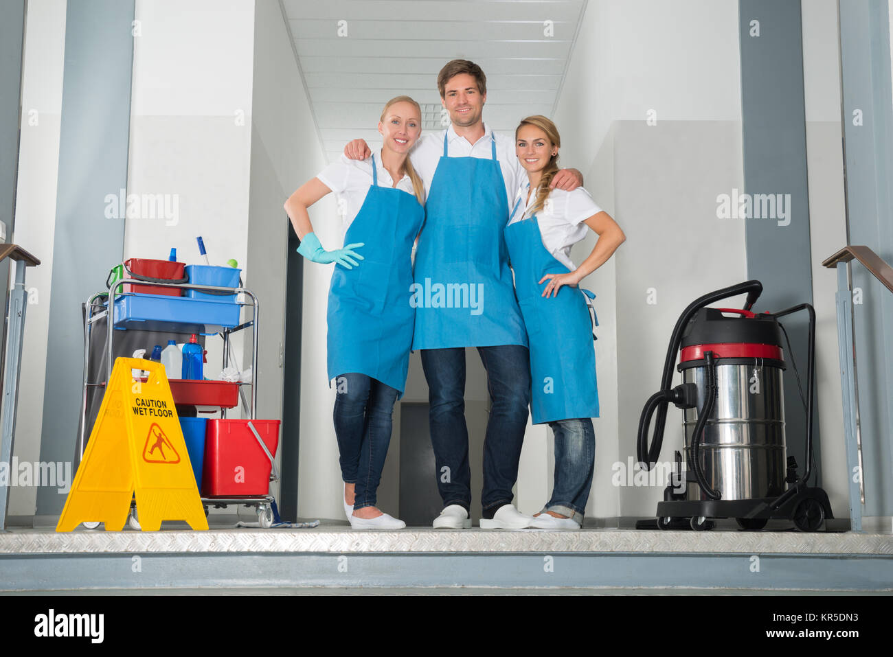 Portrait Of Janitors Holding Cleaning Equipments Stock Photo - Alamy