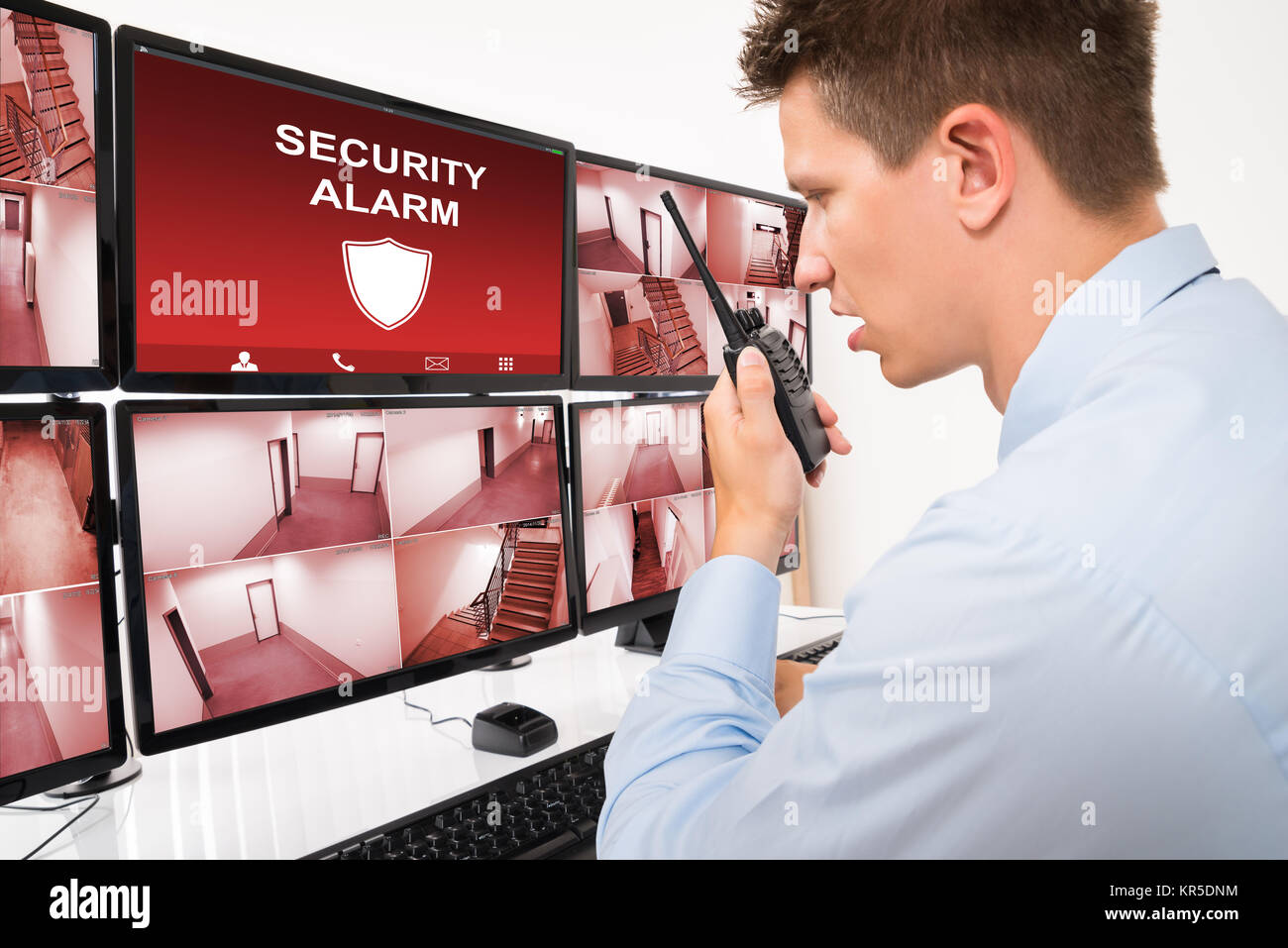 Young Male Security Guard Using Walkie-talkie Stock Photo - Alamy