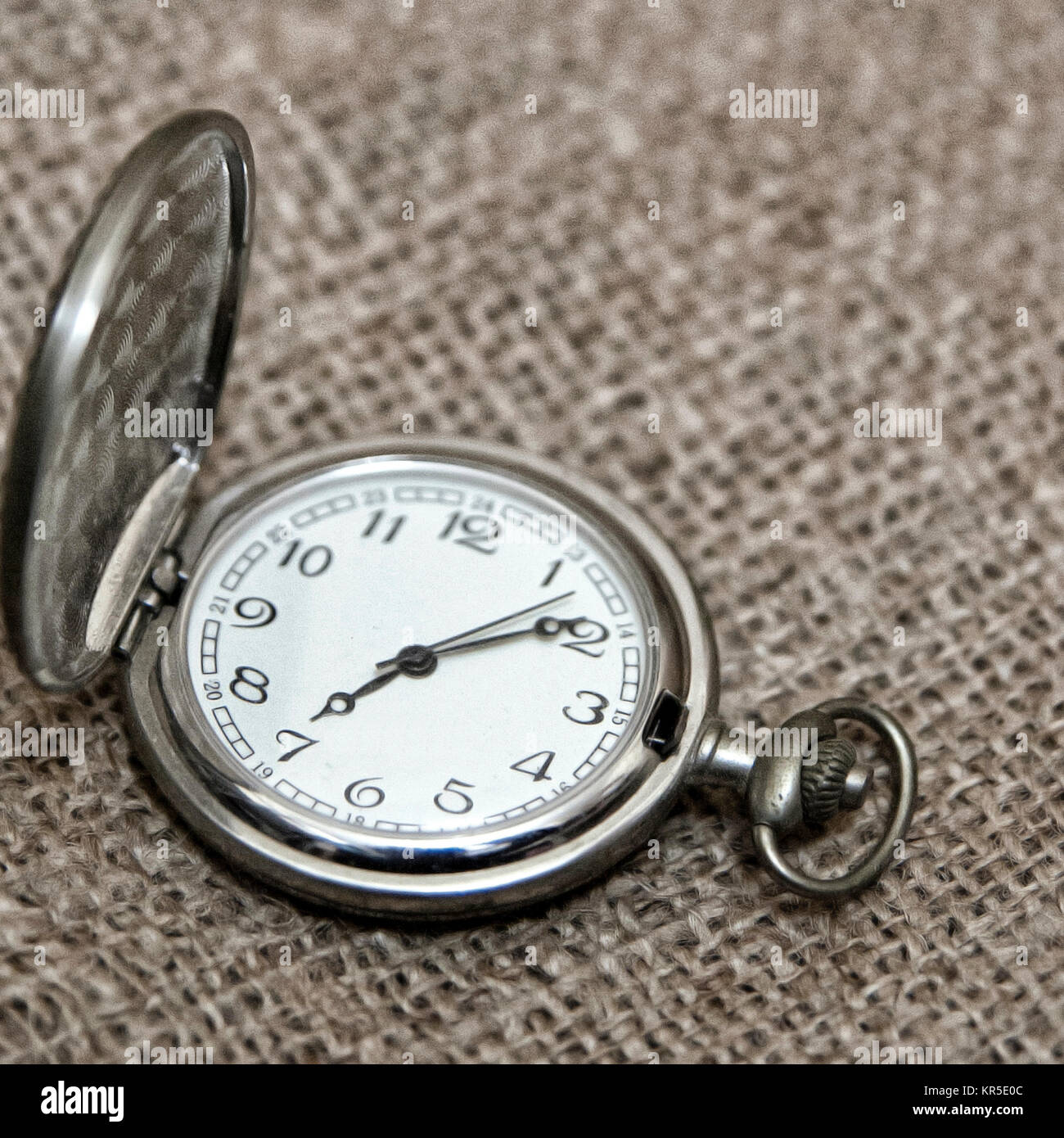 Old pocket clock on jute - time concept Stock Photo - Alamy