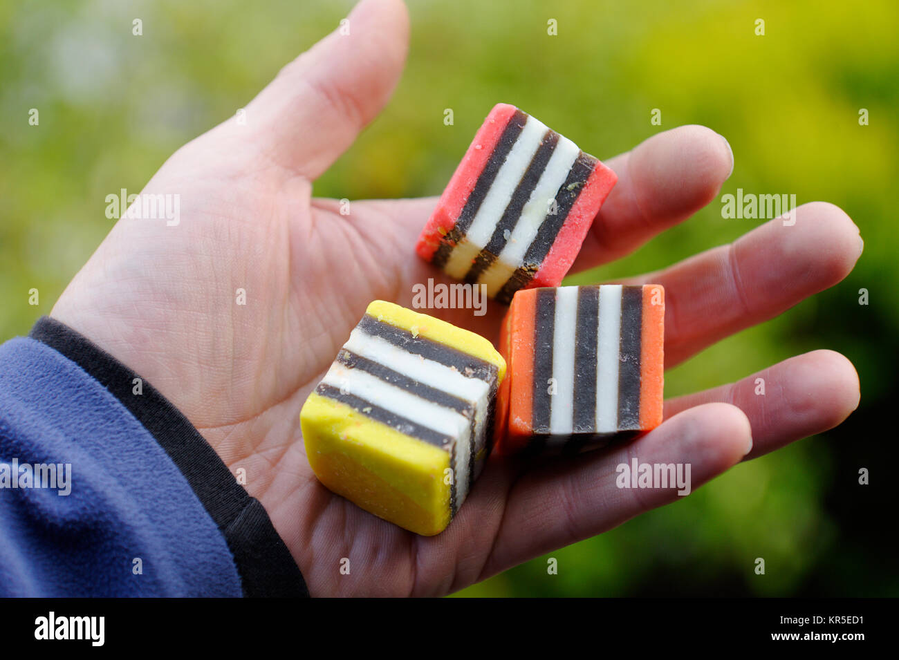 Hand with candy Stock Photo - Alamy