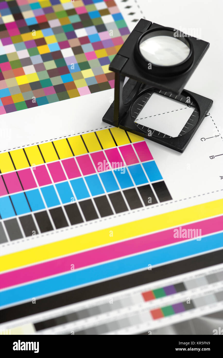 Shallow depth of field photo of a printers loupe on printed sheet ...