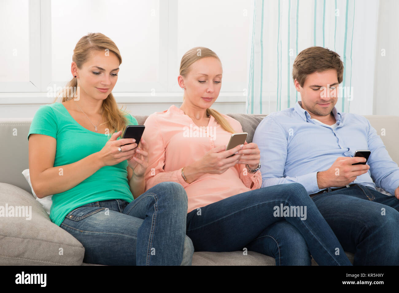Group Of People Using Mobile Phone Stock Photo - Alamy