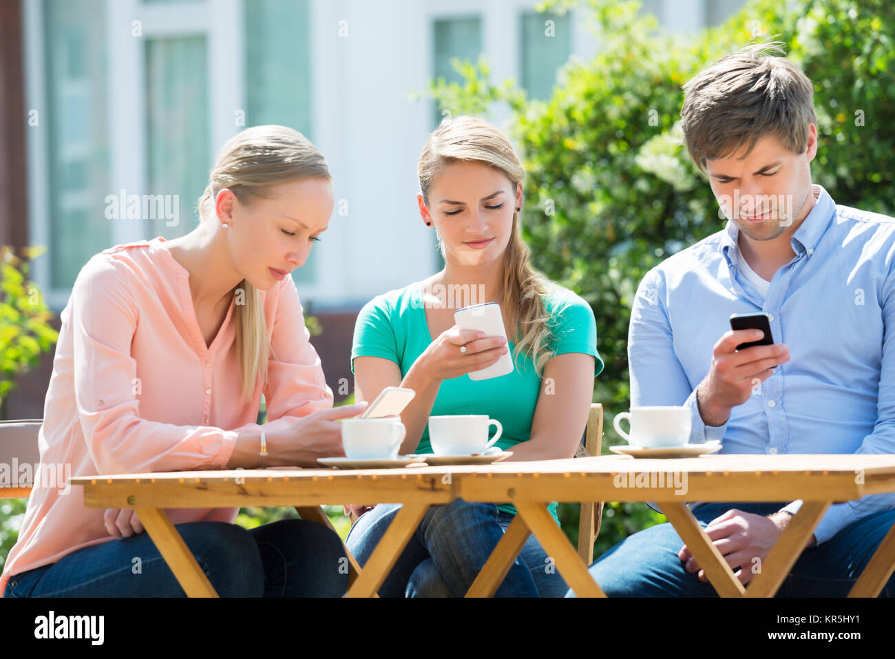 Group Of Friends Using Mobile Phone Stock Photo - Alamy