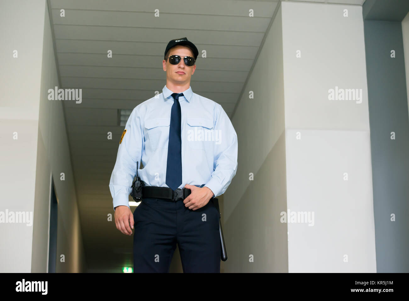 Security Guard Standing At The Entrance Stock Photo - Alamy