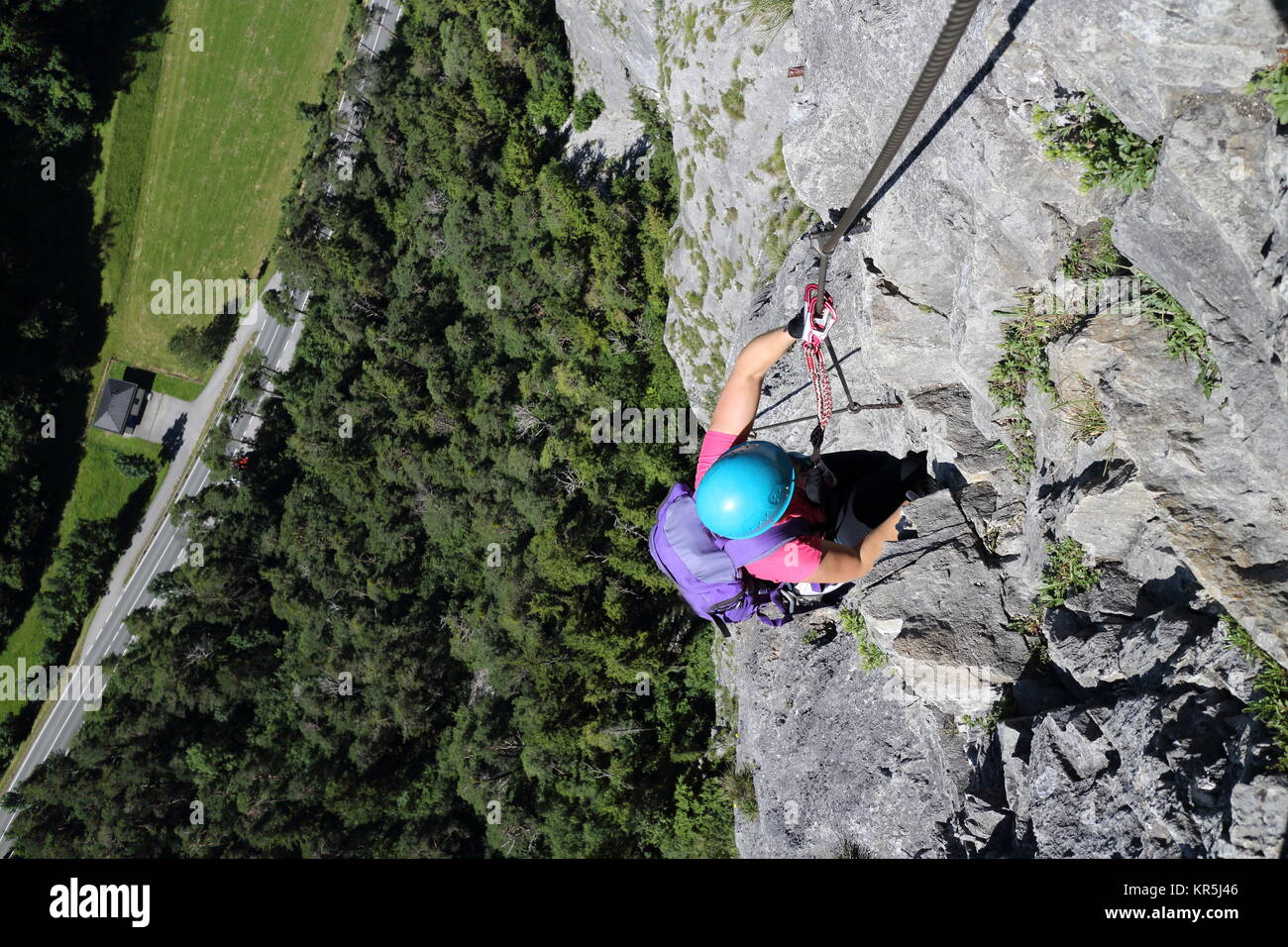 steep climbing wall with woman Stock Photo - Alamy