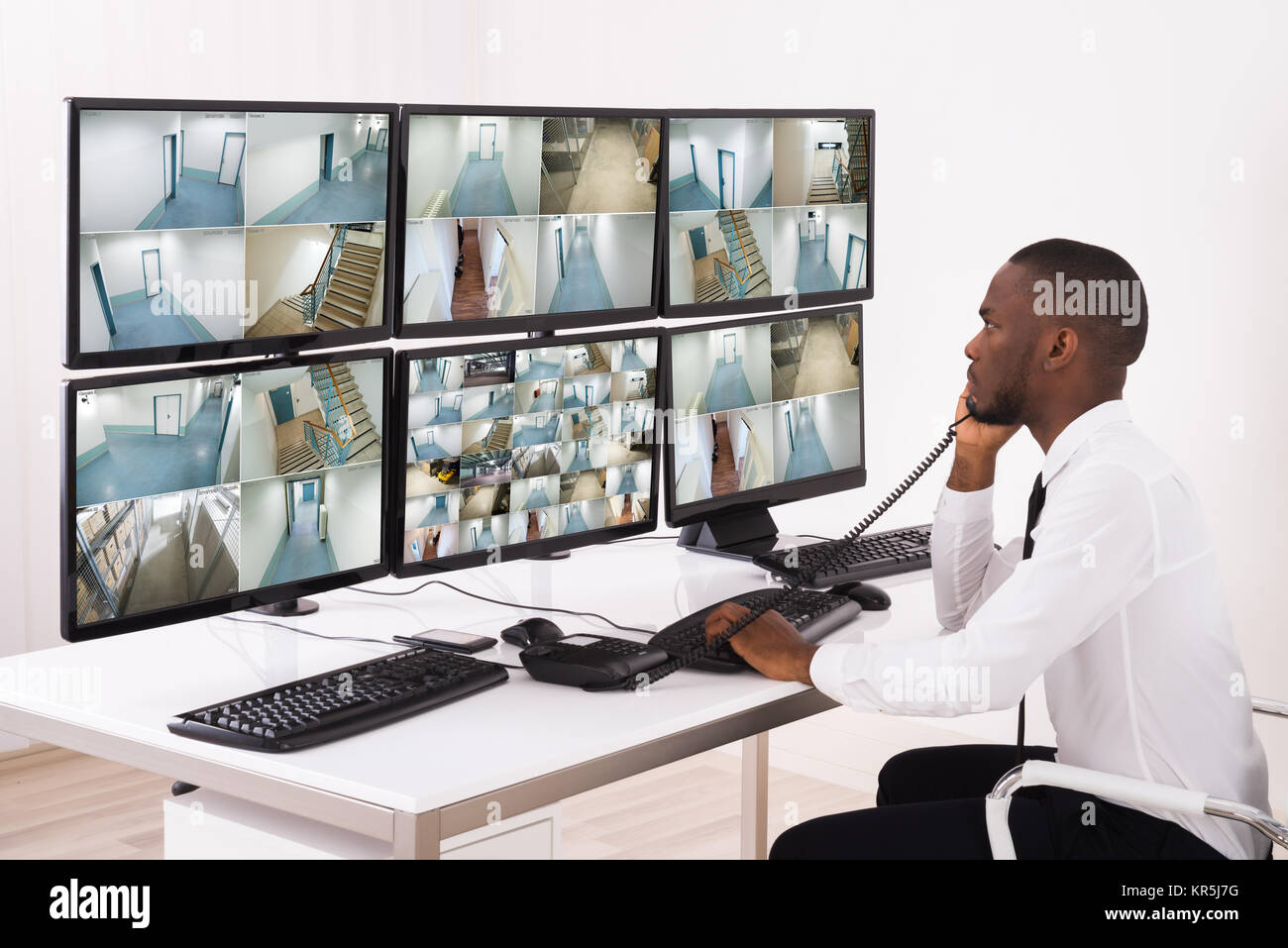 Security System Operator Talking On Phone Stock Photo - Alamy