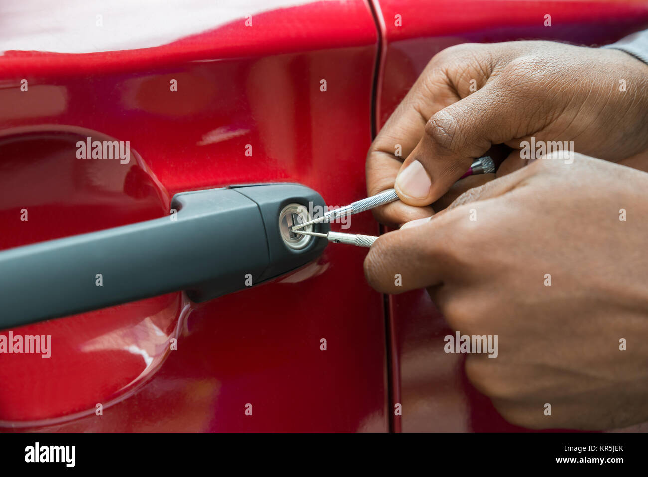 Person Hand Opening Car Door With Lockpicker Stock Photo - Alamy