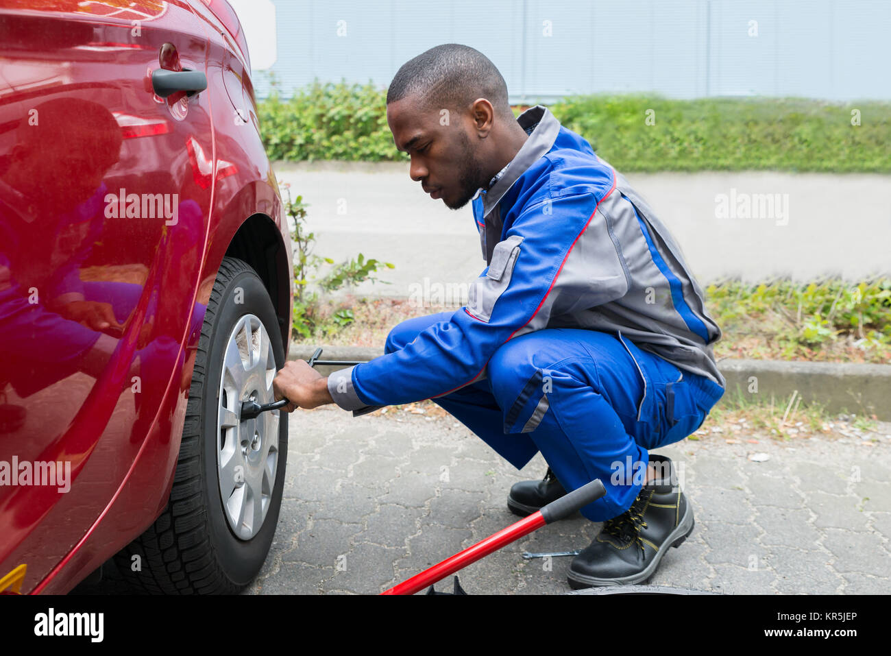 Person changing flat tyre hi-res stock photography and images - Alamy