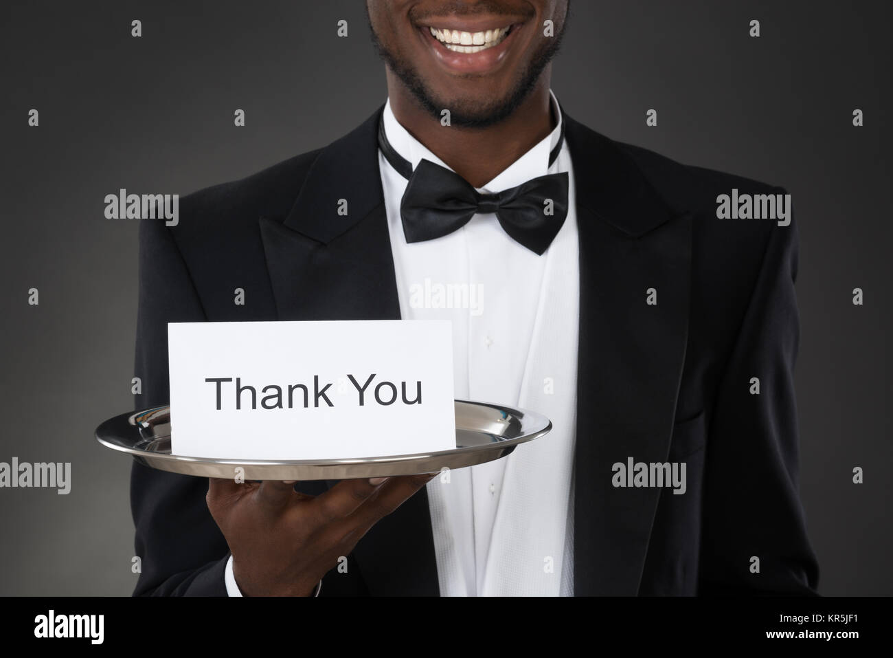 Waiter Holding Thank You Card In Tray Stock Photo - Alamy