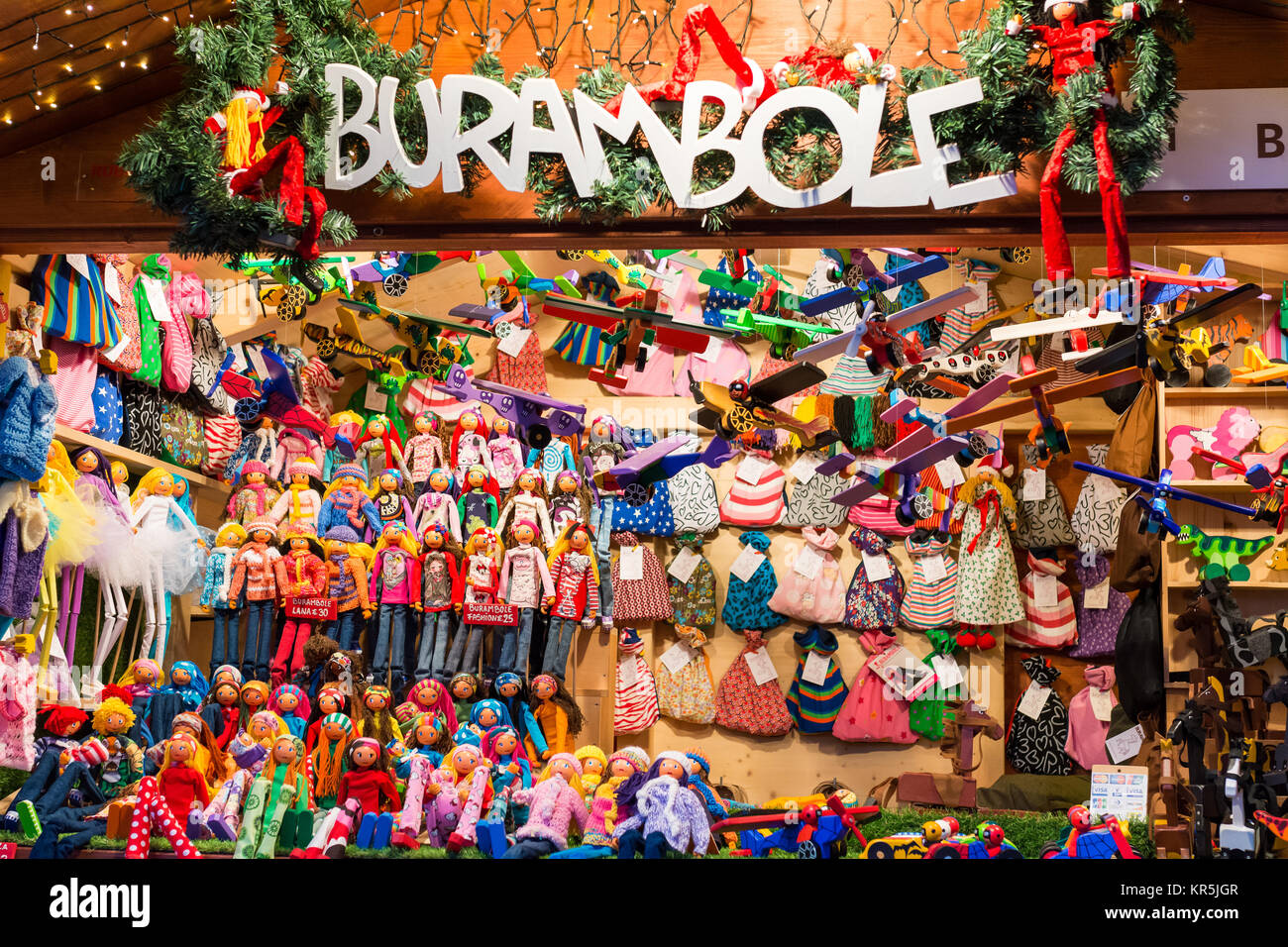 A display of toy rag dolls made from wood and bright colorful cloth ...