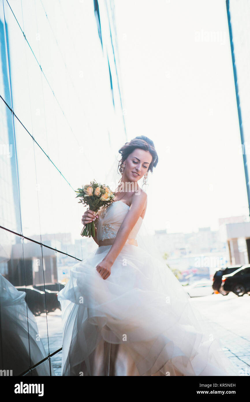 Bride and bouquet on backround mirror buildings Stock Photo - Alamy