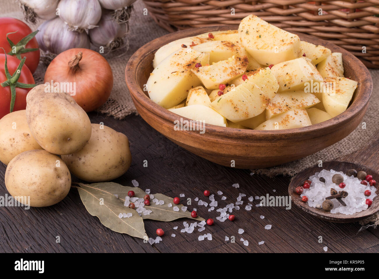 Potatoes in a clay bowl on the old wooden table Stock Photo - Alamy